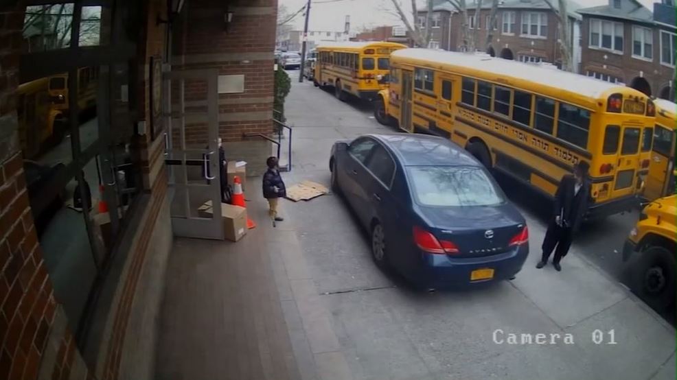 Video: Car jumps sidewalk to go around school buses nearly hits ...